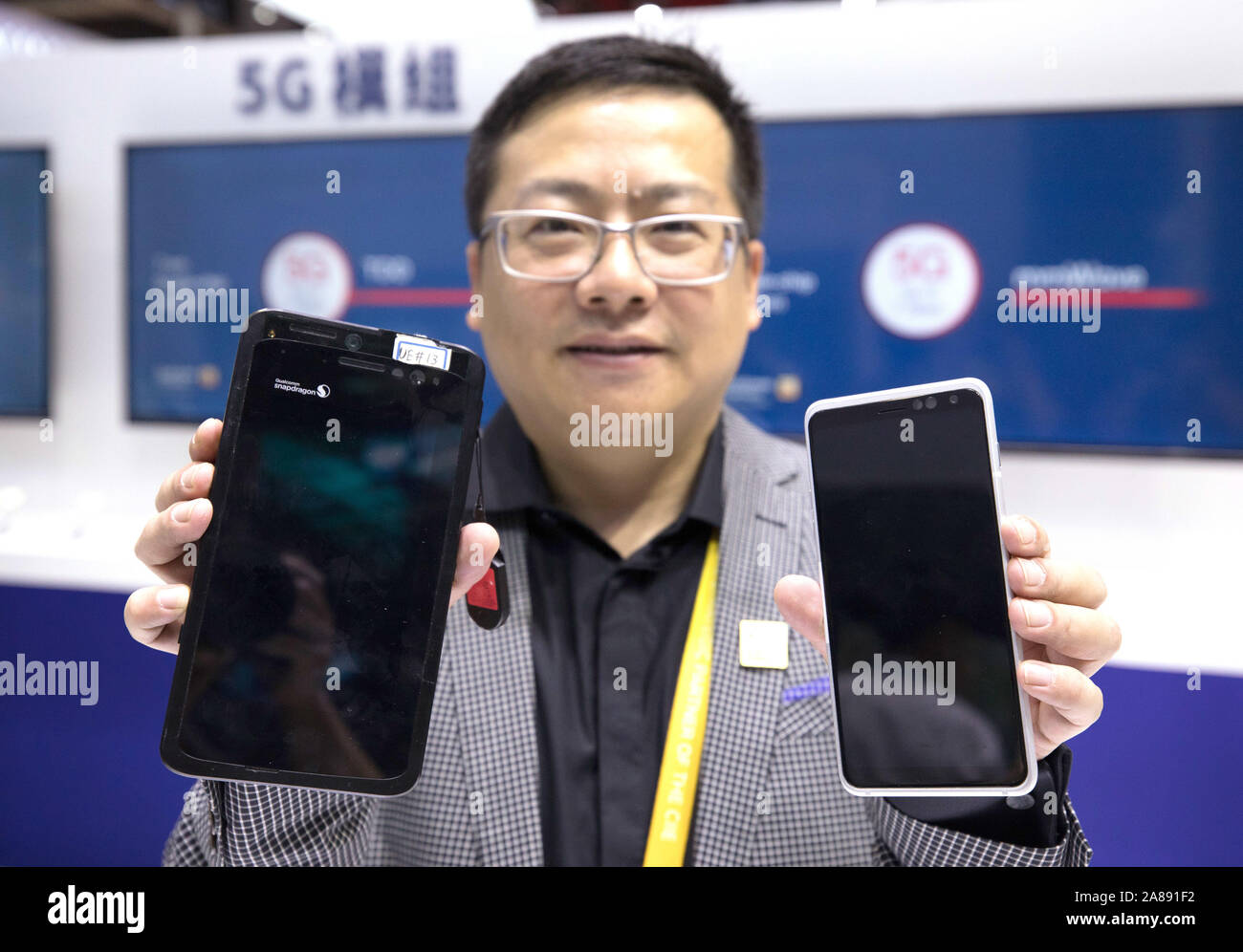Shanghai, China. 7th Nov, 2019. A staff member of Qualcomm presents 5G ...