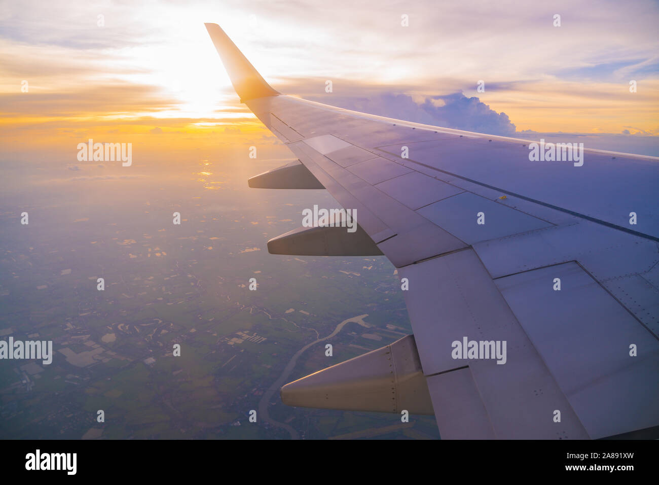 Beautiful sunset, sky on the top view, airplane flying view from inside ...