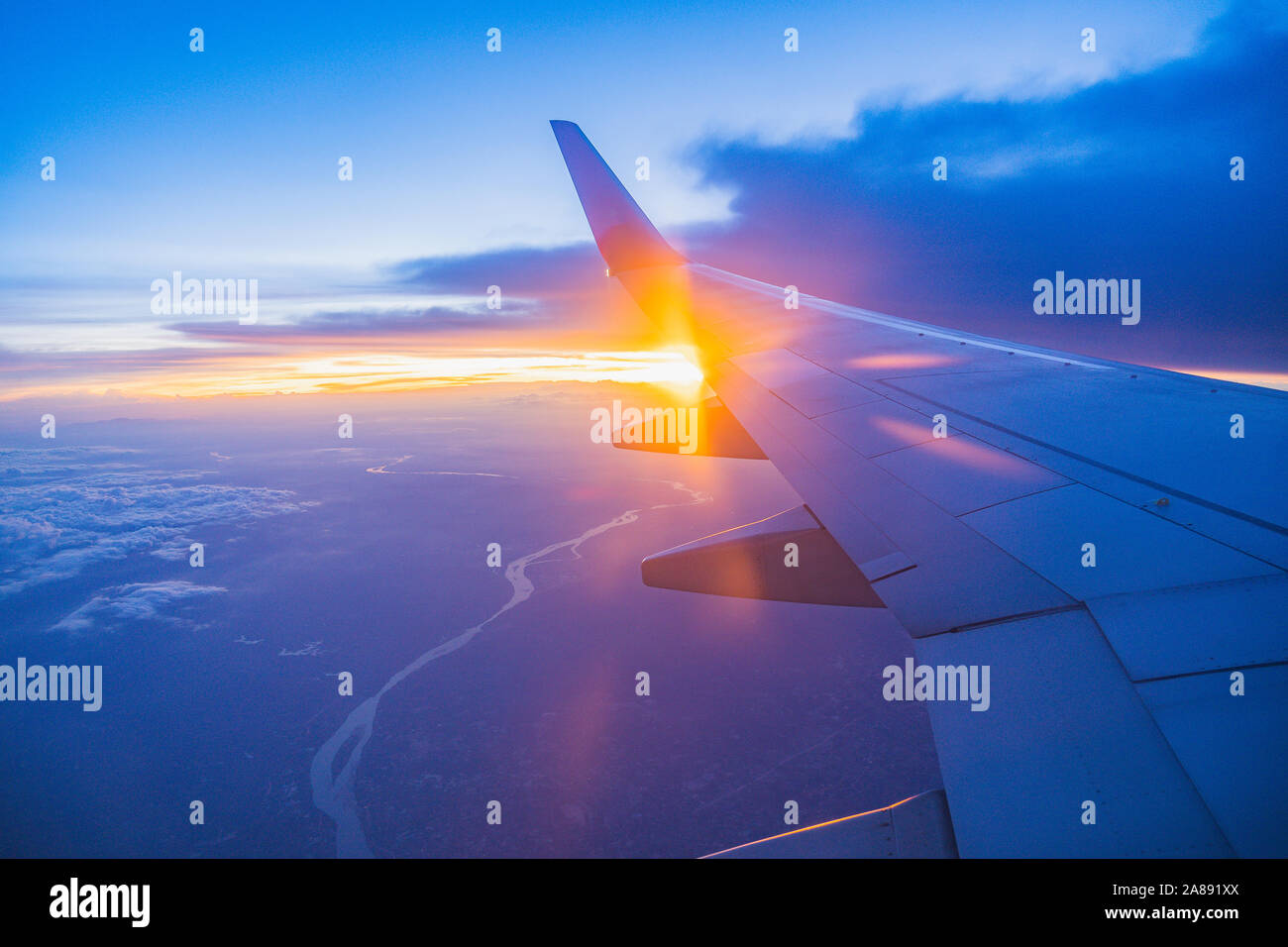 Beautiful sunset, sky on the top view, airplane flying view from inside ...