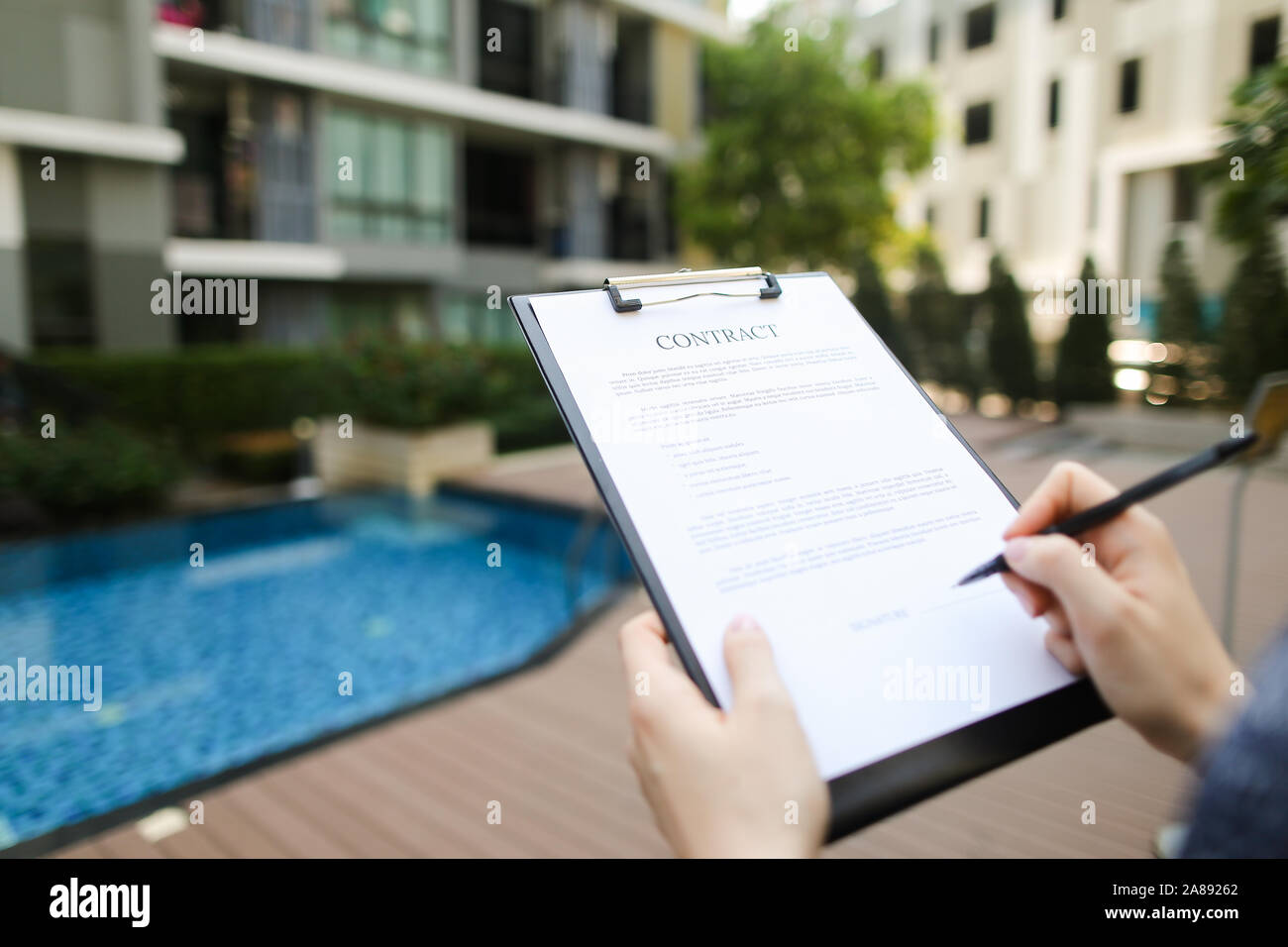 Close-up of woman's hand sign contract against background of new Stock ...