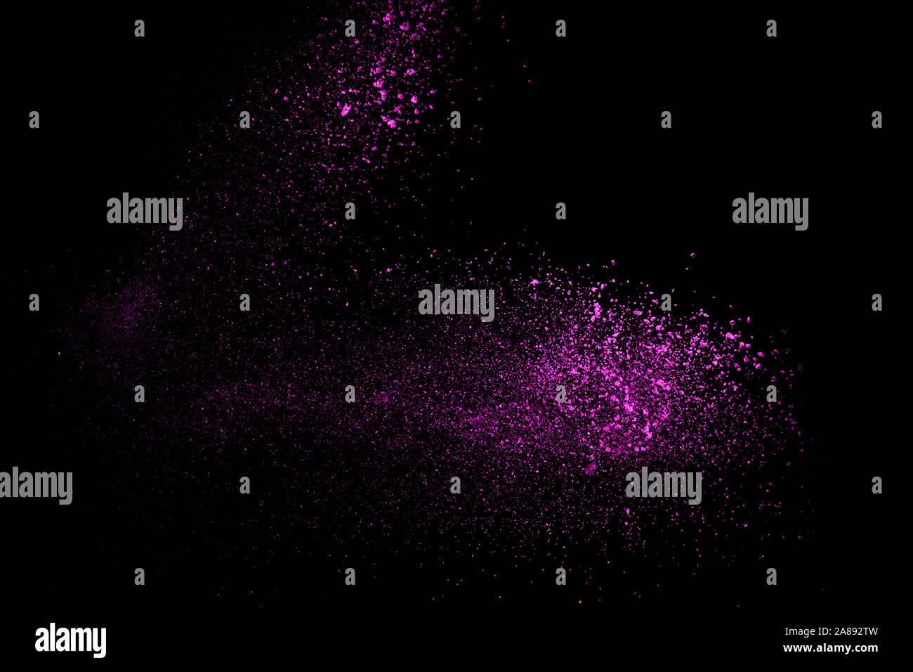 Abstract pink dust explosion on black background. Freeze motion of pink ...