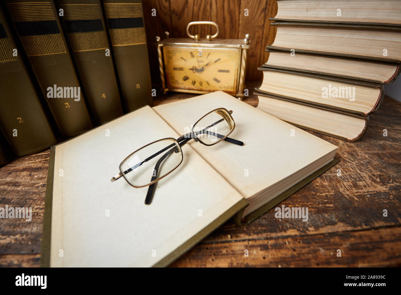 An open book in a library on a table Stock Photo - Alamy