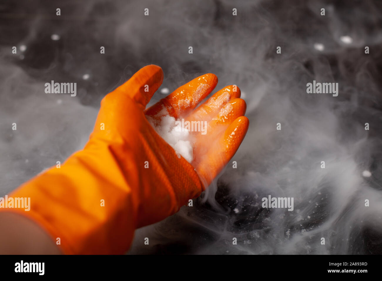 Thick white smoke on a background of black ceramic tiles. Dry ice ...