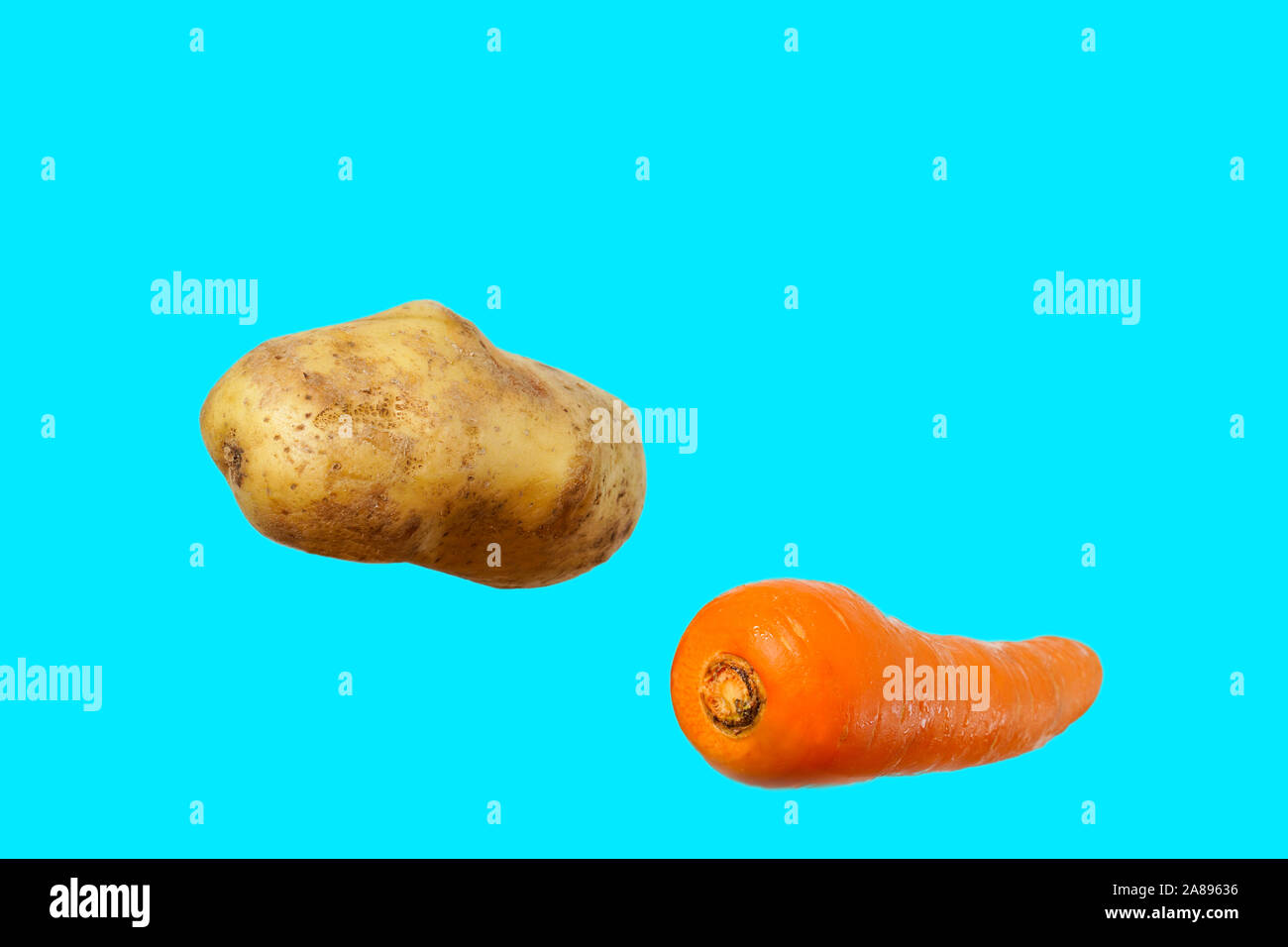 Fresh floating potato and carrot isolated with blue backgrund Stock ...