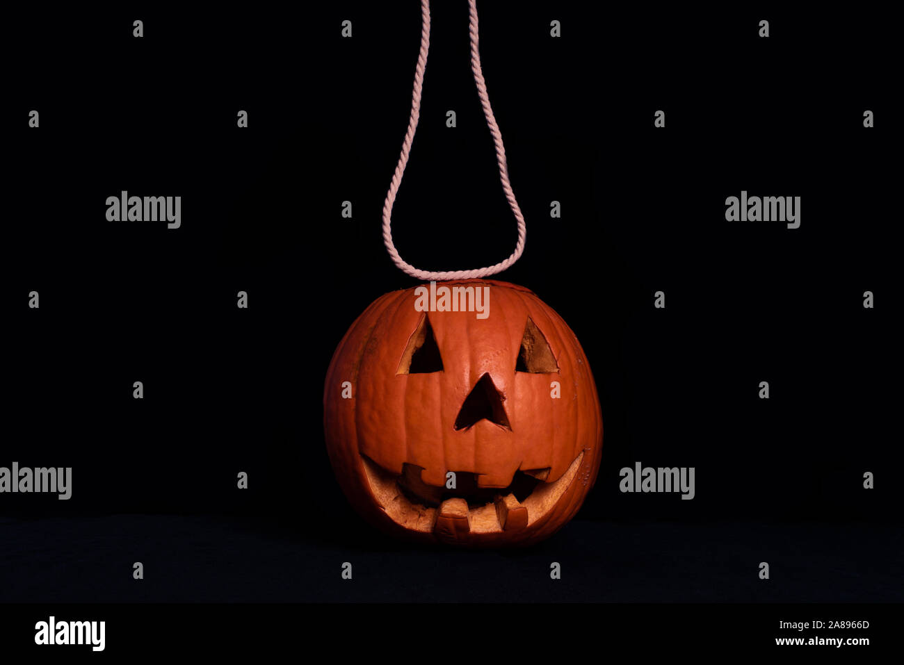 Pumpkin suspended on a rope. Preparation for Halloween.Orange squash on ...