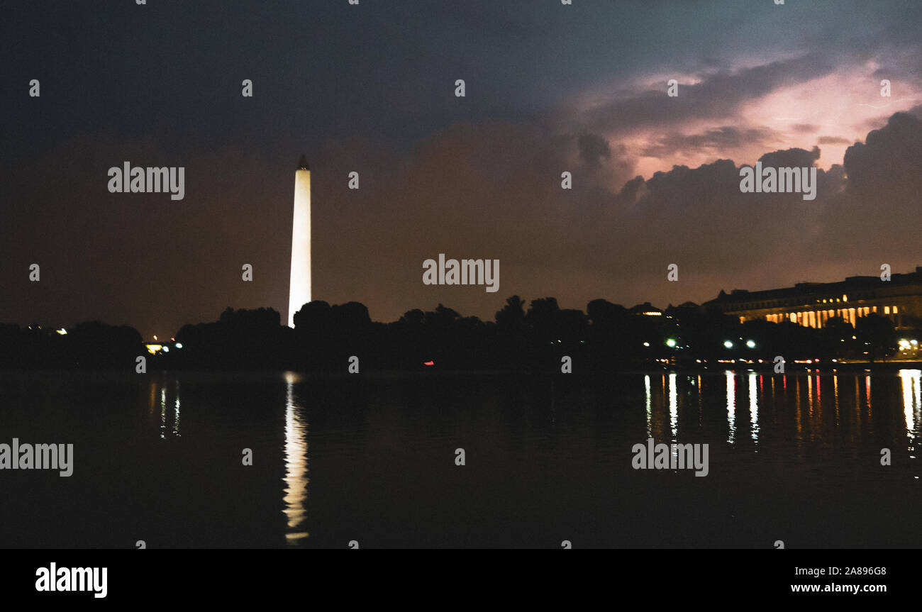Washington Monument at night during a lightning storm across a lake ...
