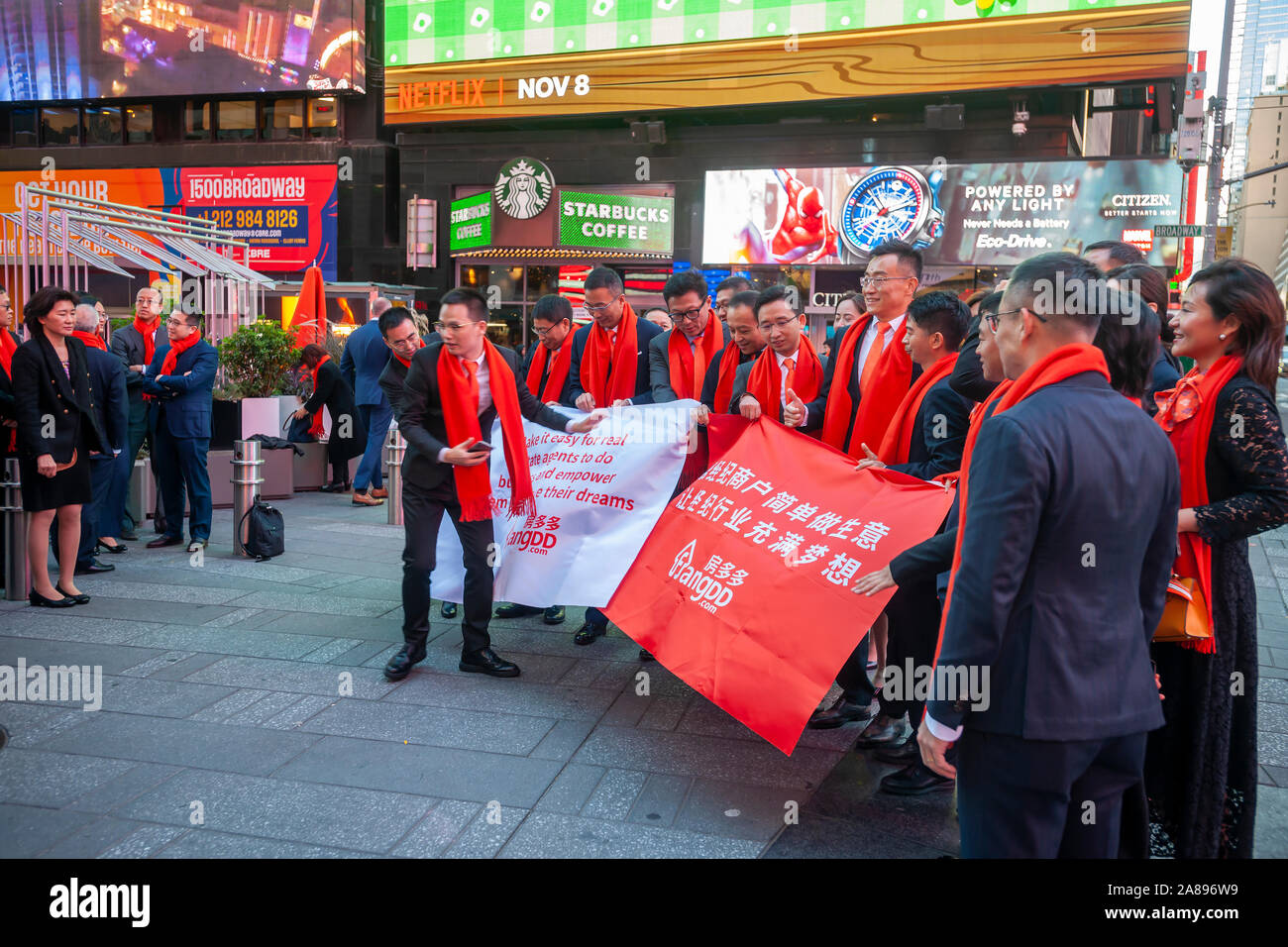 Employees with their families and friends gather at the giant video ...