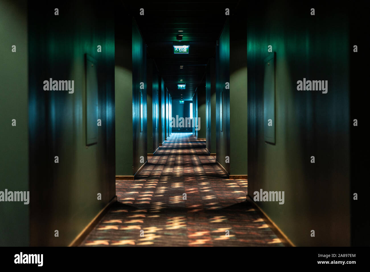 Dark, lonely and dark hallway with light at the end inside a modern ...