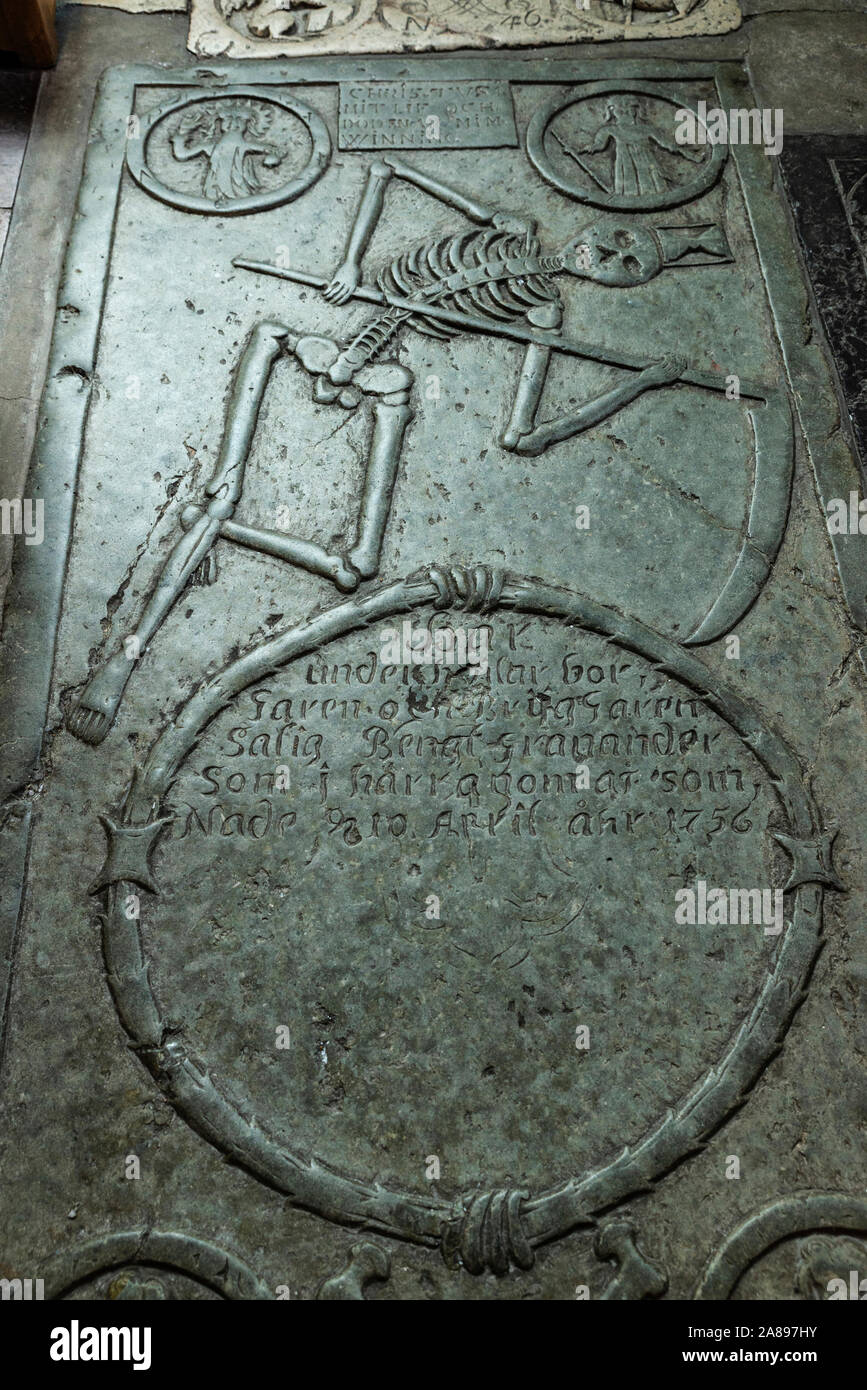 Tomb with a relief of a skeleton with a sickle in the interior of the ...
