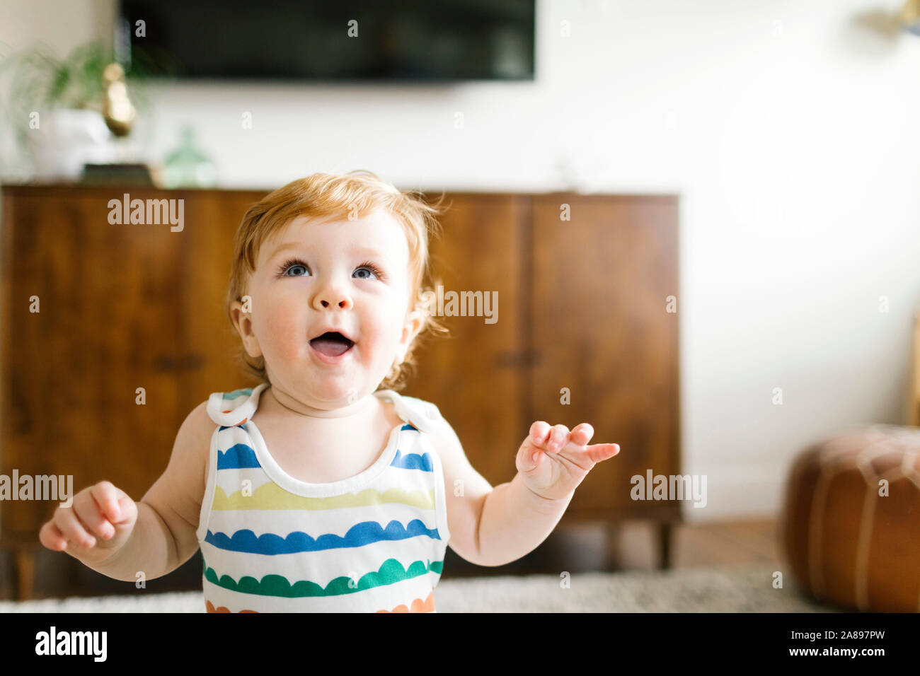 Baby boy looking up Stock Photo - Alamy