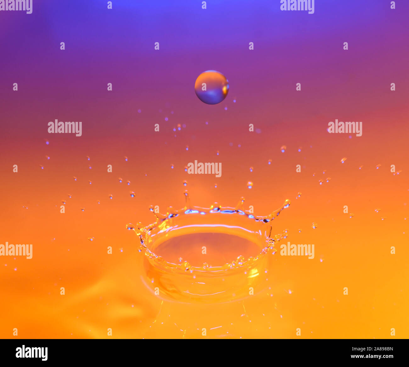 Orange and purple splashing water Stock Photo - Alamy