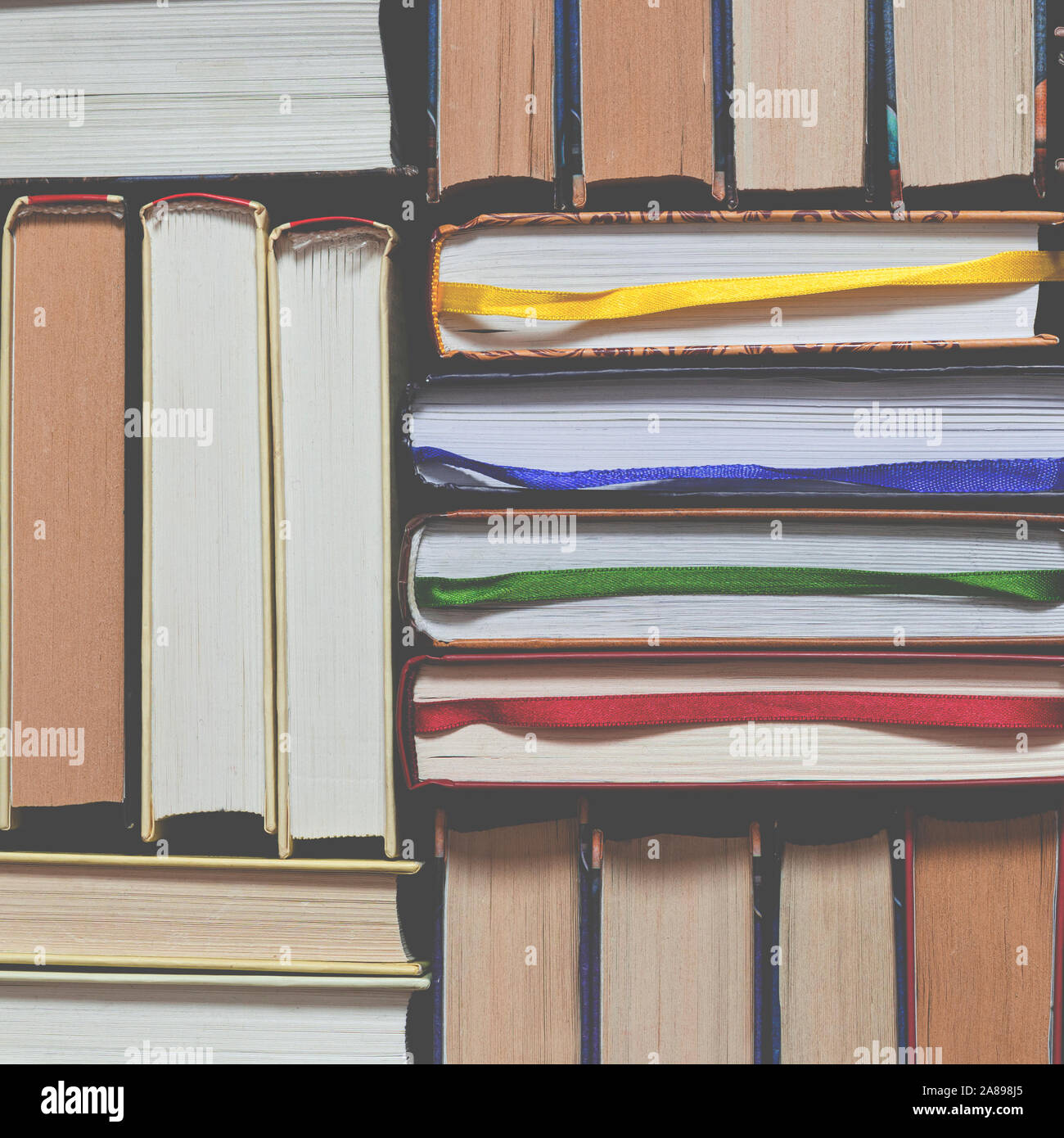 Lots of colourful thick open books stand on a dark background Stock ...