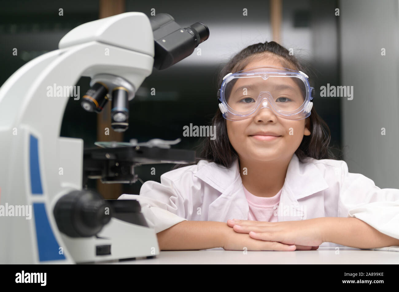 Happy Little child smile and learning in school laboratory using ...