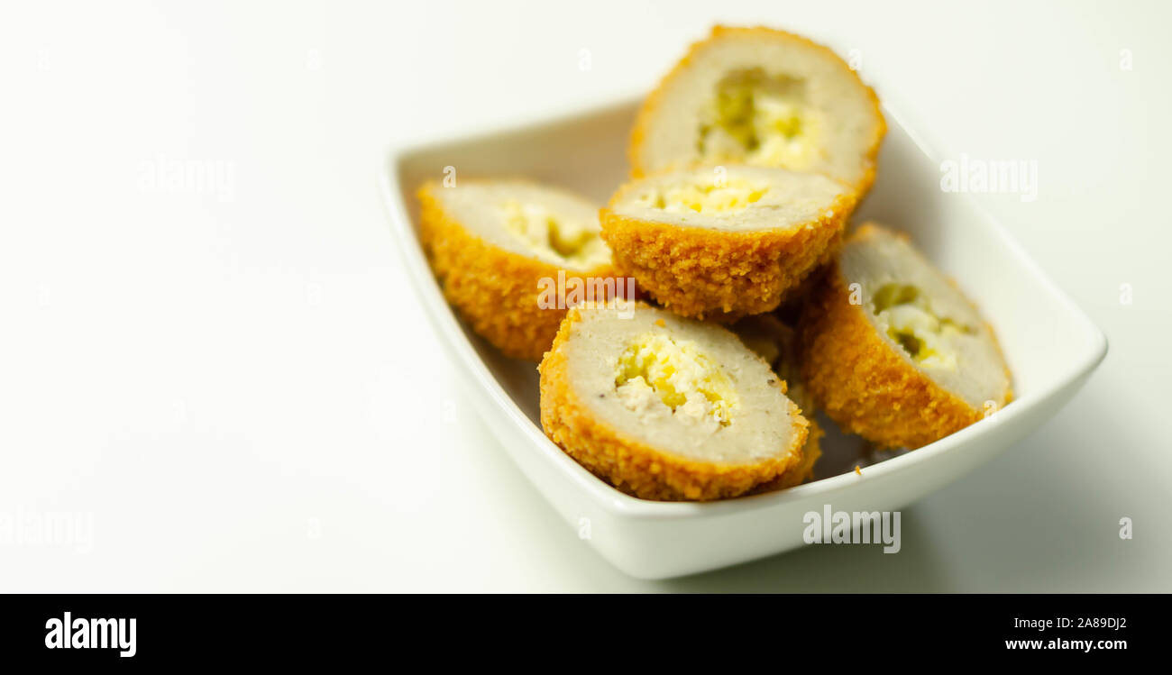 Savory mini scotch eggs in white ceramic bowl, traditional English ...