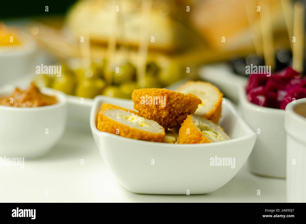 Savory mini scotch eggs in white ceramic bowl, traditional English ...