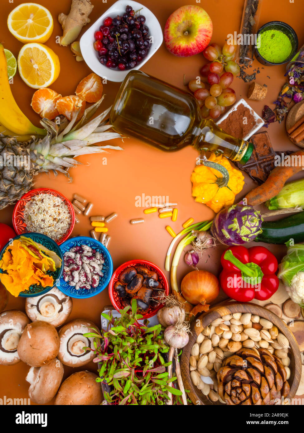 Mixed colorful foods as nuts, fruits, vegetables, beans, herbs, powders ...