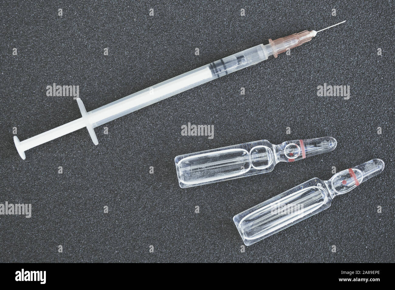 Syringes and vials of medicine on pavement. Hospital treatment ...