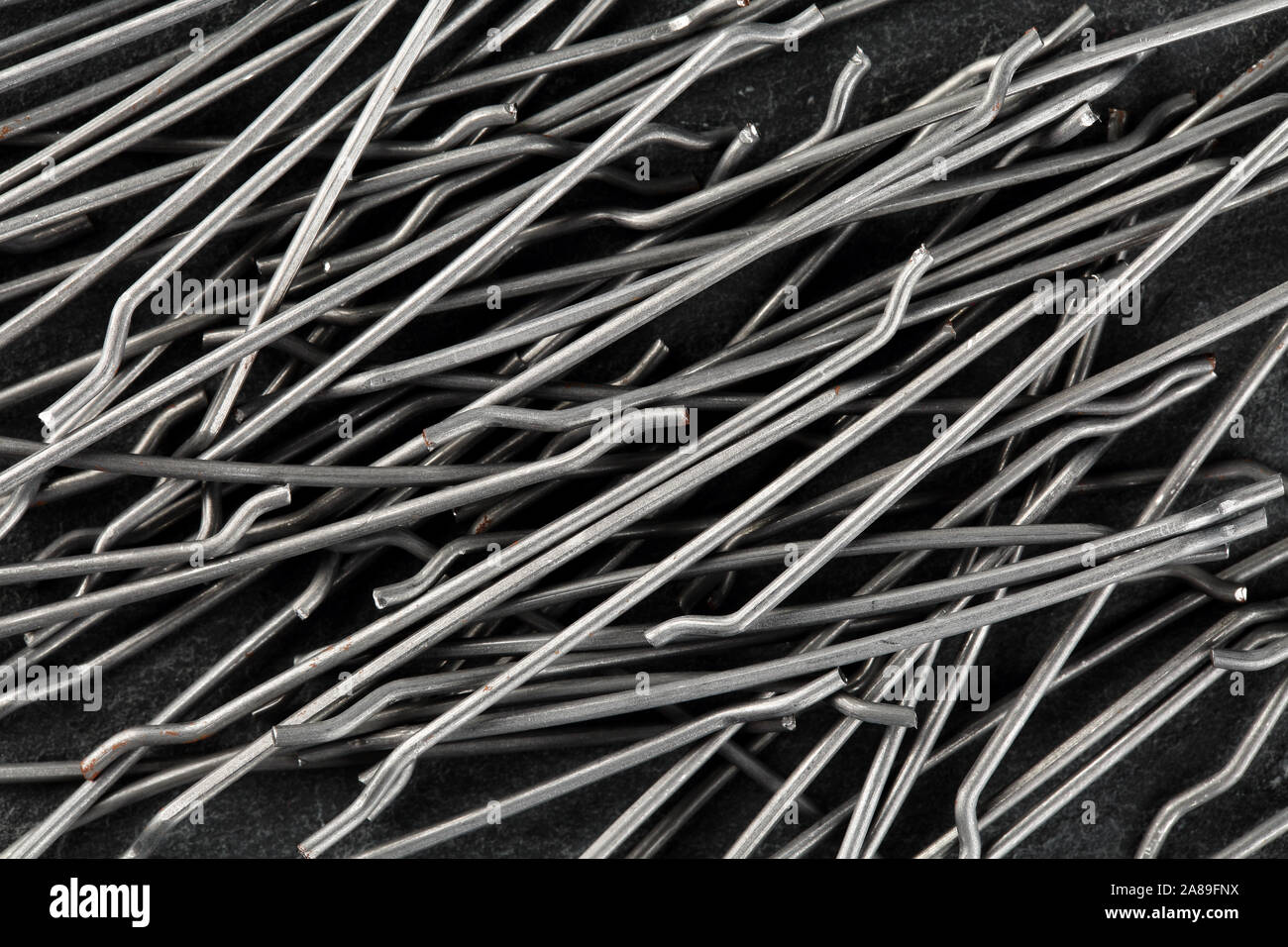 Extreme close up, top down view of end hooked steel macro fibers for ...