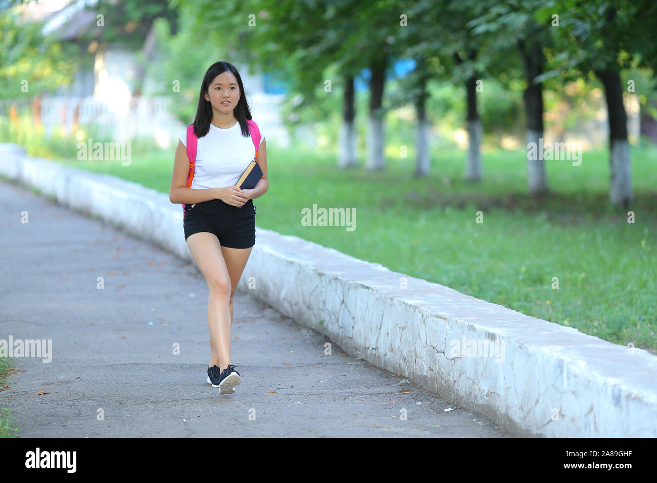 Young girl walking in the park are walking gait Stock Photo - Alamy