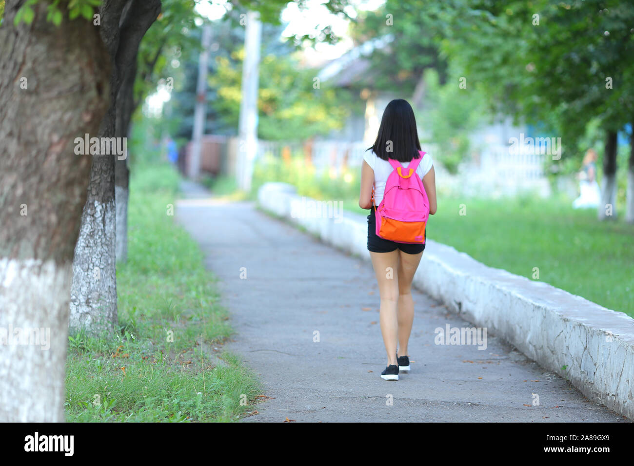 Young girl walking in the park are walking gait Stock Photo - Alamy