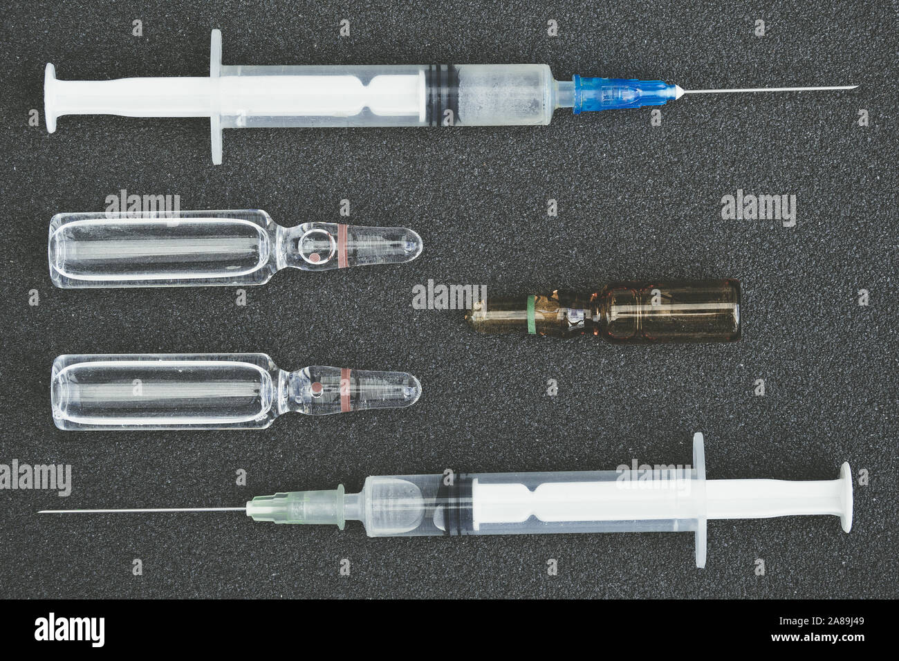 Syringes and vials of medicine on pavement. Hospital treatment ...