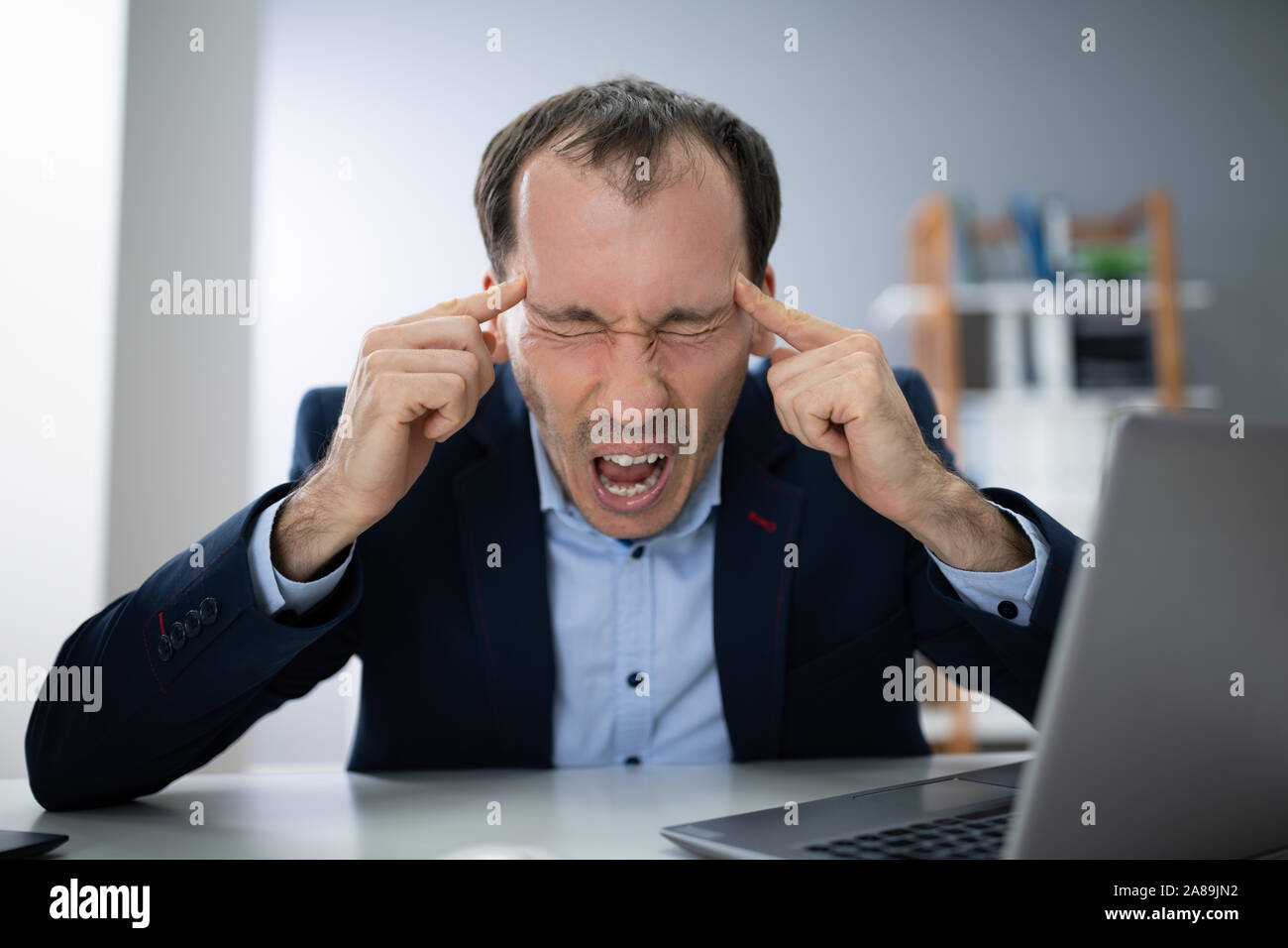 Stressed Young Businessman Screaming In The Office Stock Photo - Alamy