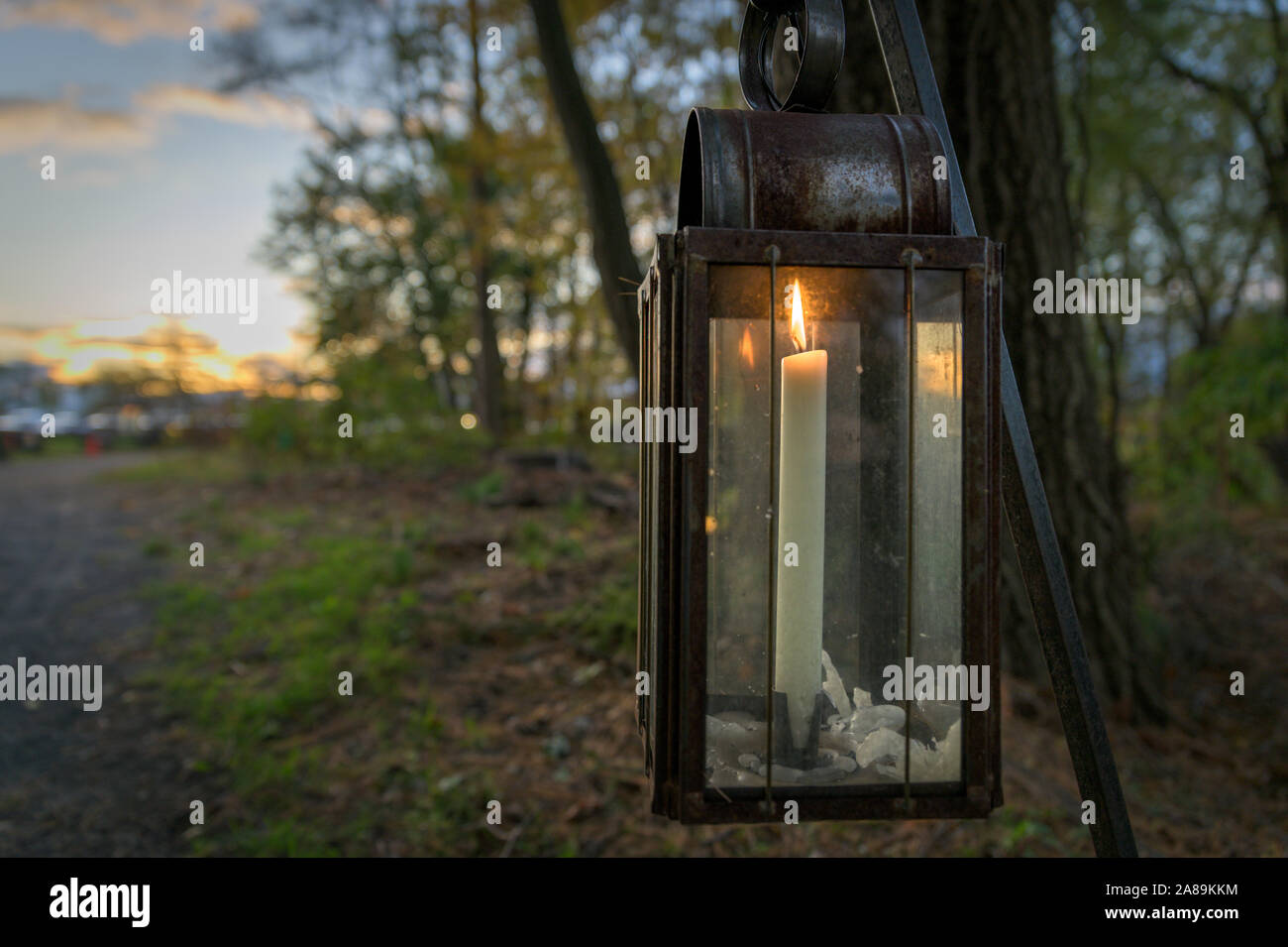 An old-fashioned candle lit lantern during early evening hours Stock ...