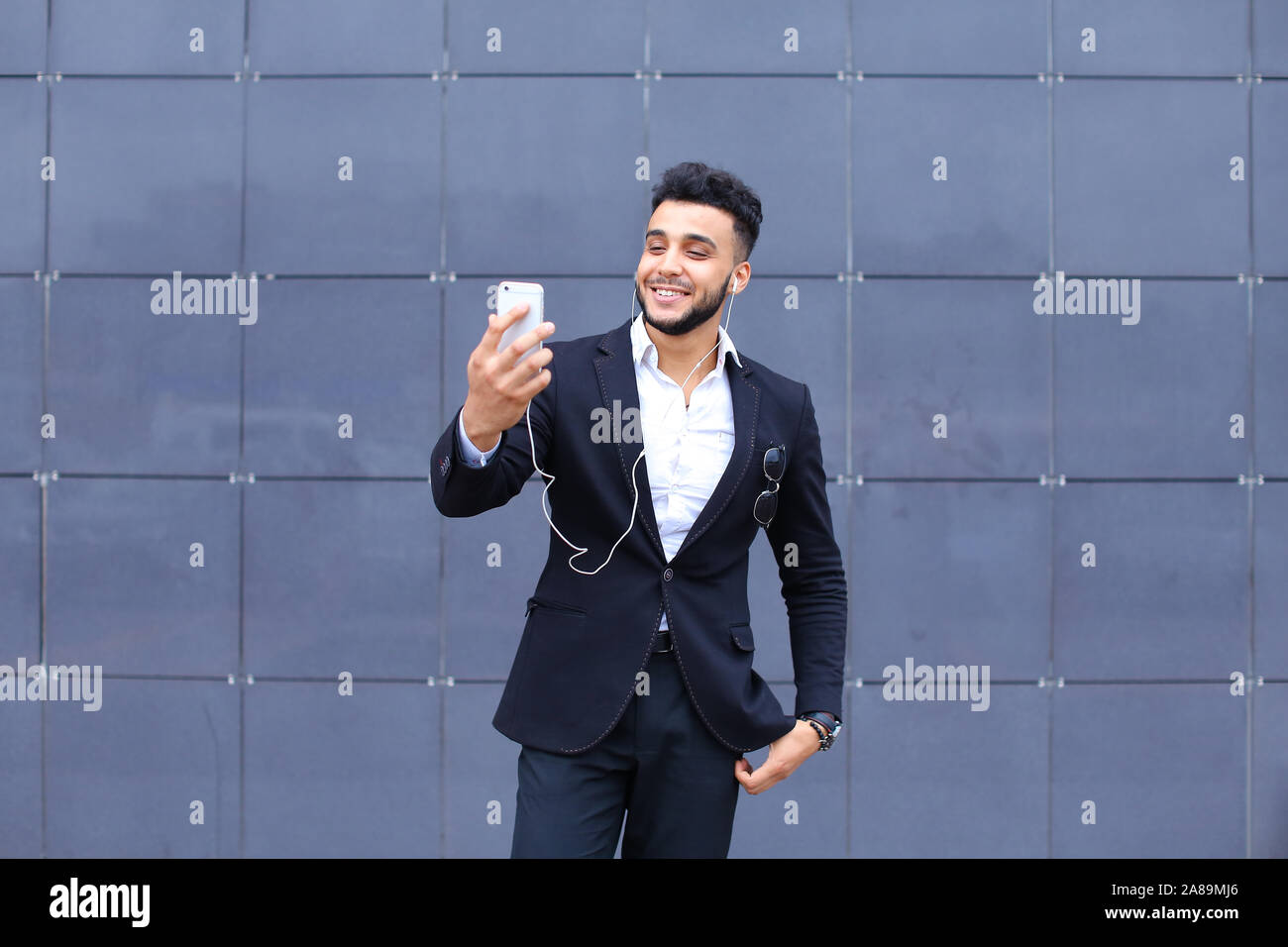 Handsome arabic man takes selfie smart phone in business center Stock ...