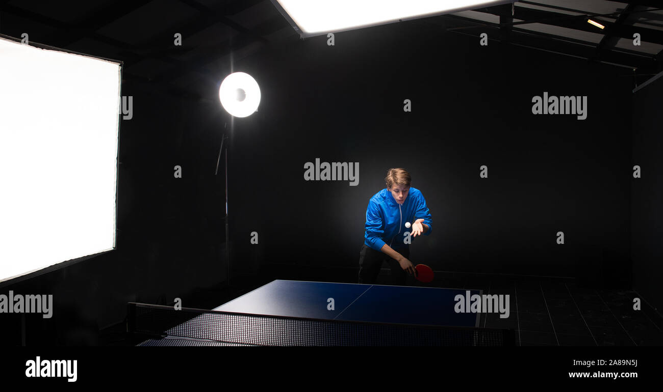 A boy is playing table tennis.on white background Stock Photo - Alamy