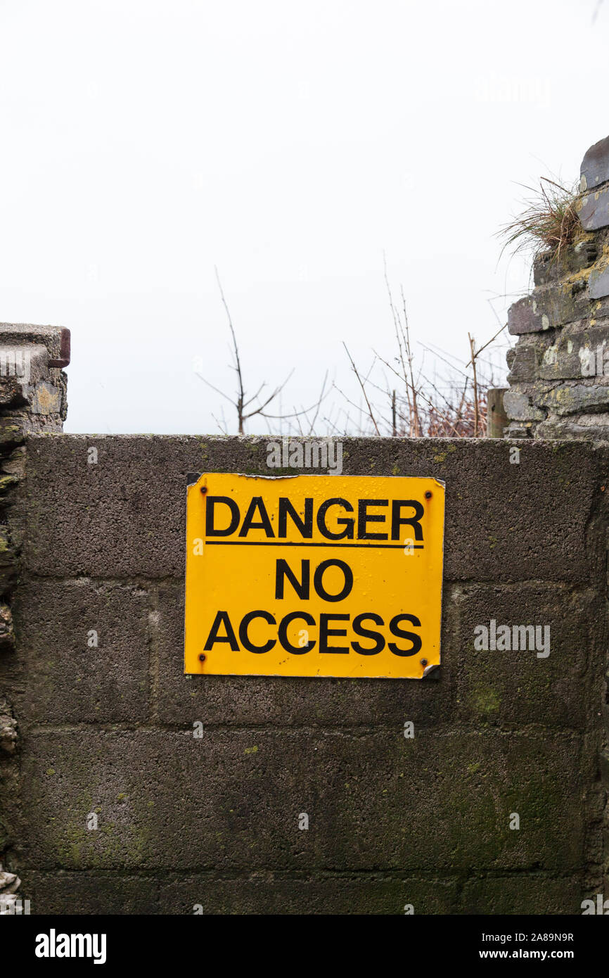 Yellow danger wall sign warning of 'no access' Stock Photo - Alamy
