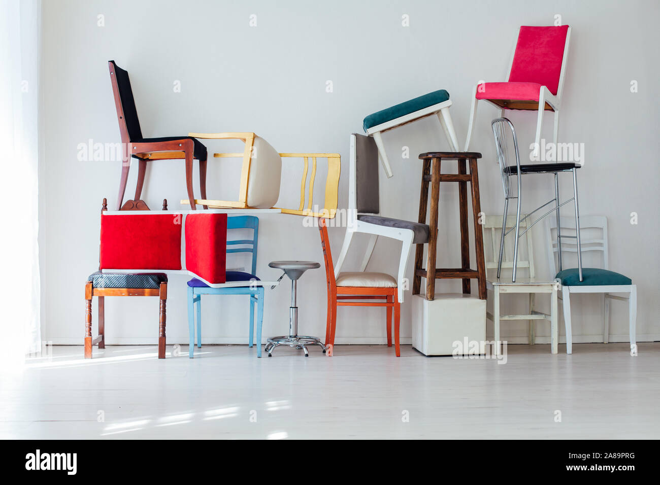 lots of different chairs in the interior of the white room Stock Photo ...