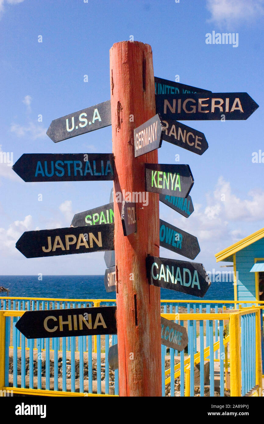 wooden signpost showing countries and distance, resort, Barbados ...