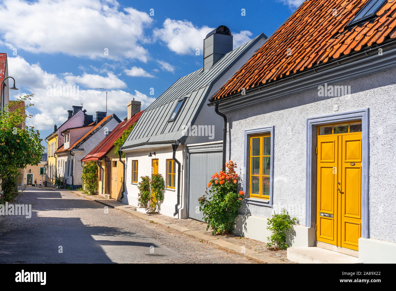 A street view with homes and buildings featuring the architecture of ...