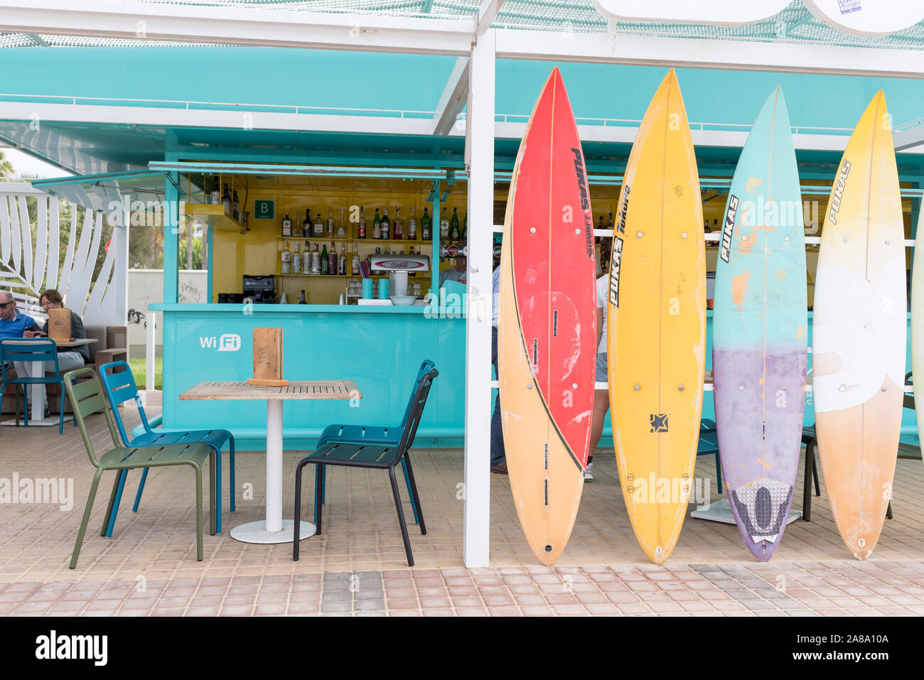 surf boards standing by cafe in resort front Stock Photo - Alamy