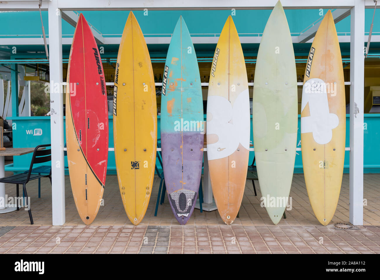 surf boards standing by cafe in resort front Stock Photo - Alamy