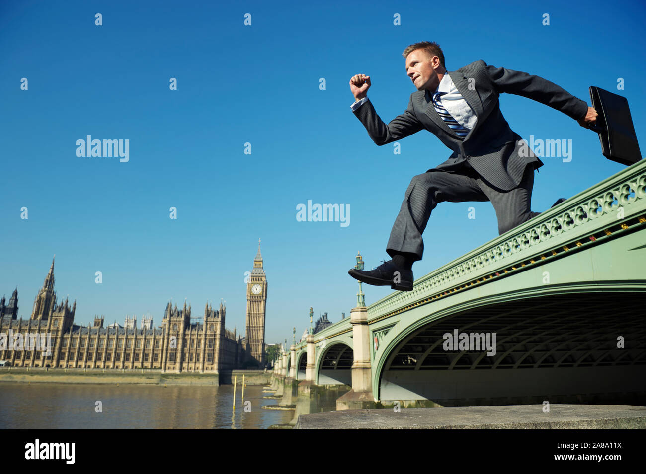 Giant businessman doing a running leap over Westminster Bridge in front ...