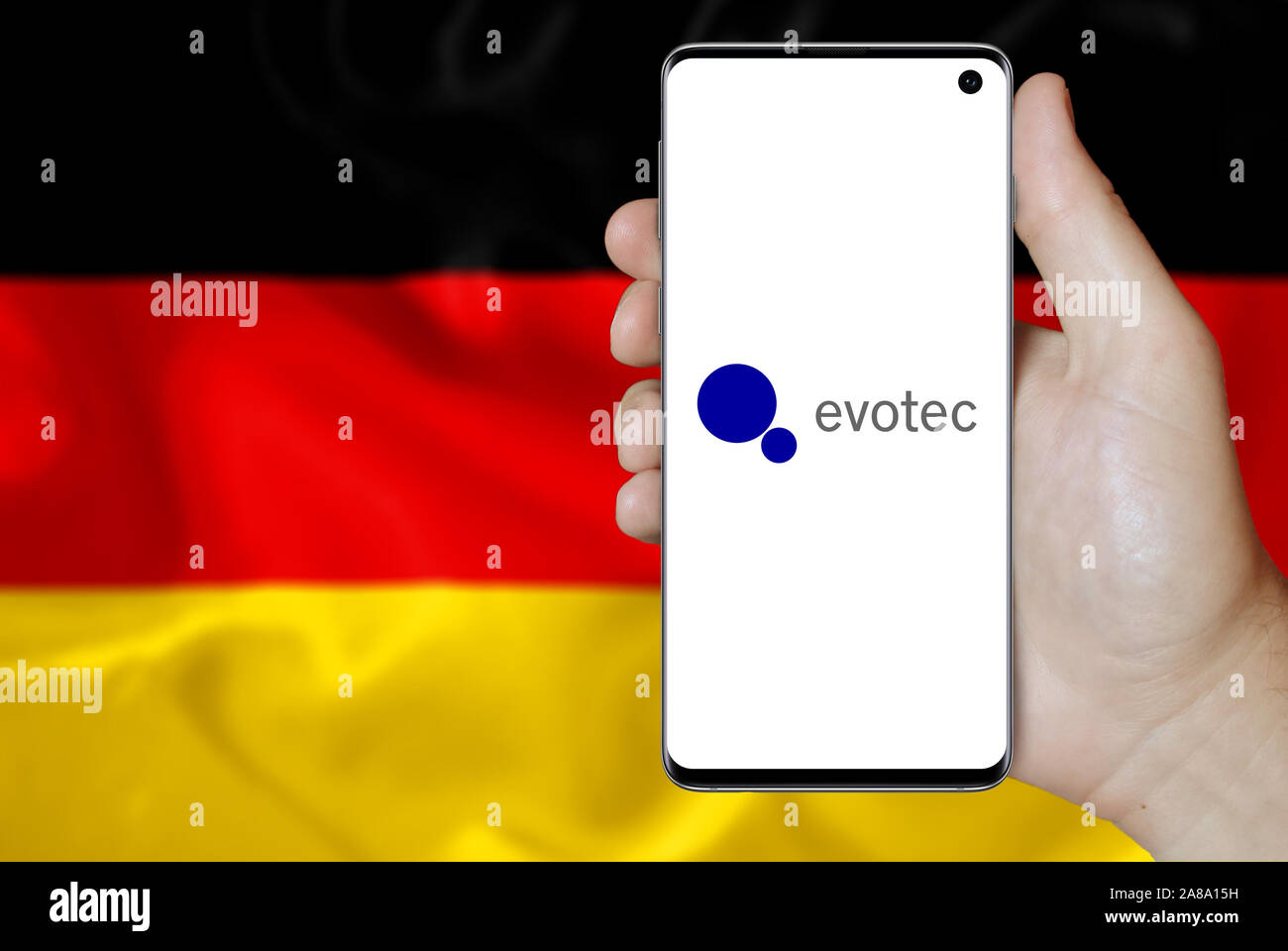 Logo of public company Evotec displayed on a smartphone. Flag of ...