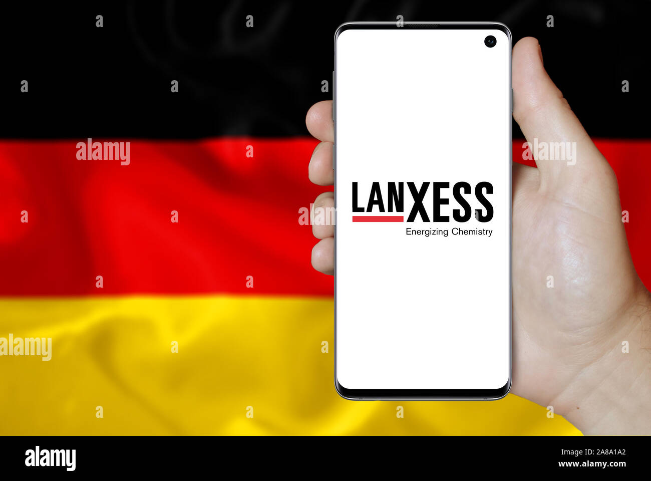 Logo of public company Lanxess AG displayed on a smartphone. Flag of ...