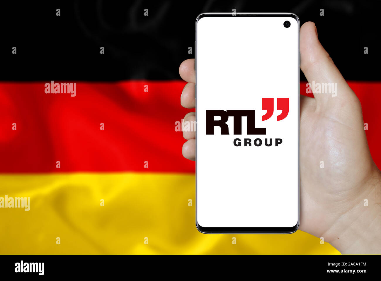 Logo of public company RTL Group displayed on a smartphone. Flag of ...