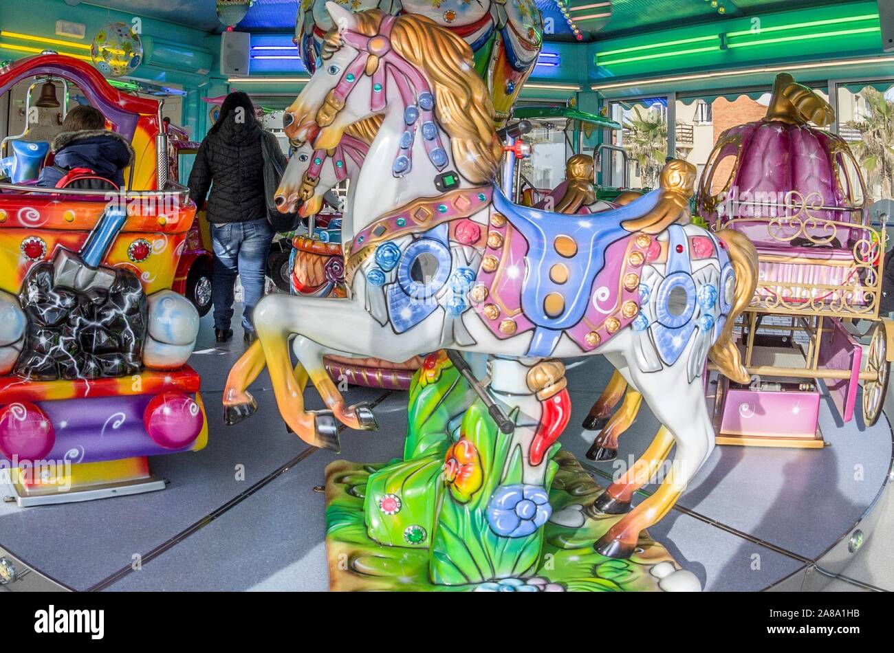 Colorful carousel at the amusement park Stock Photo - Alamy