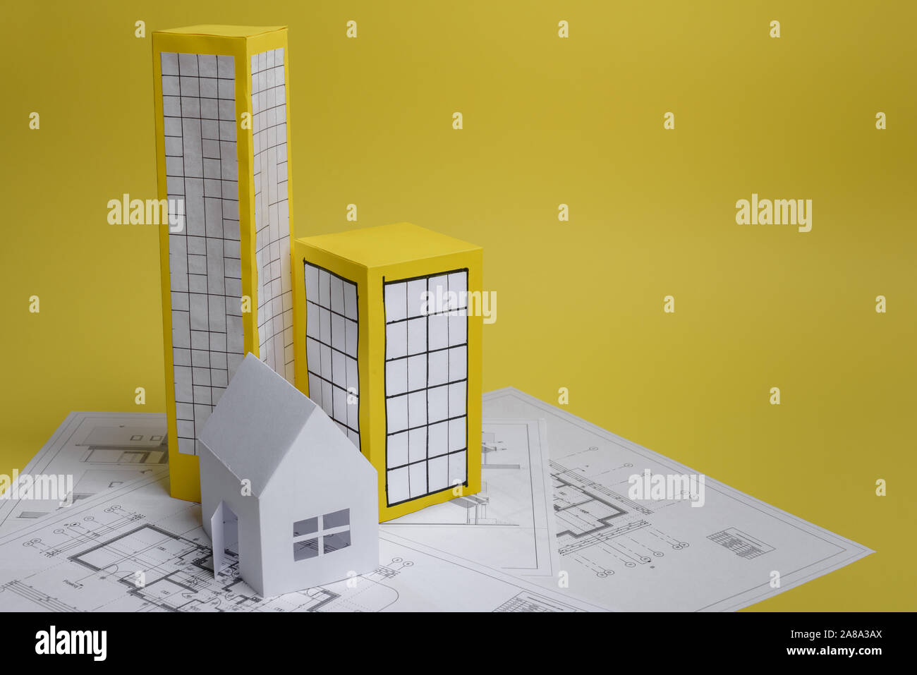 White family paper house, house projects plan and blueprints on yellow ...