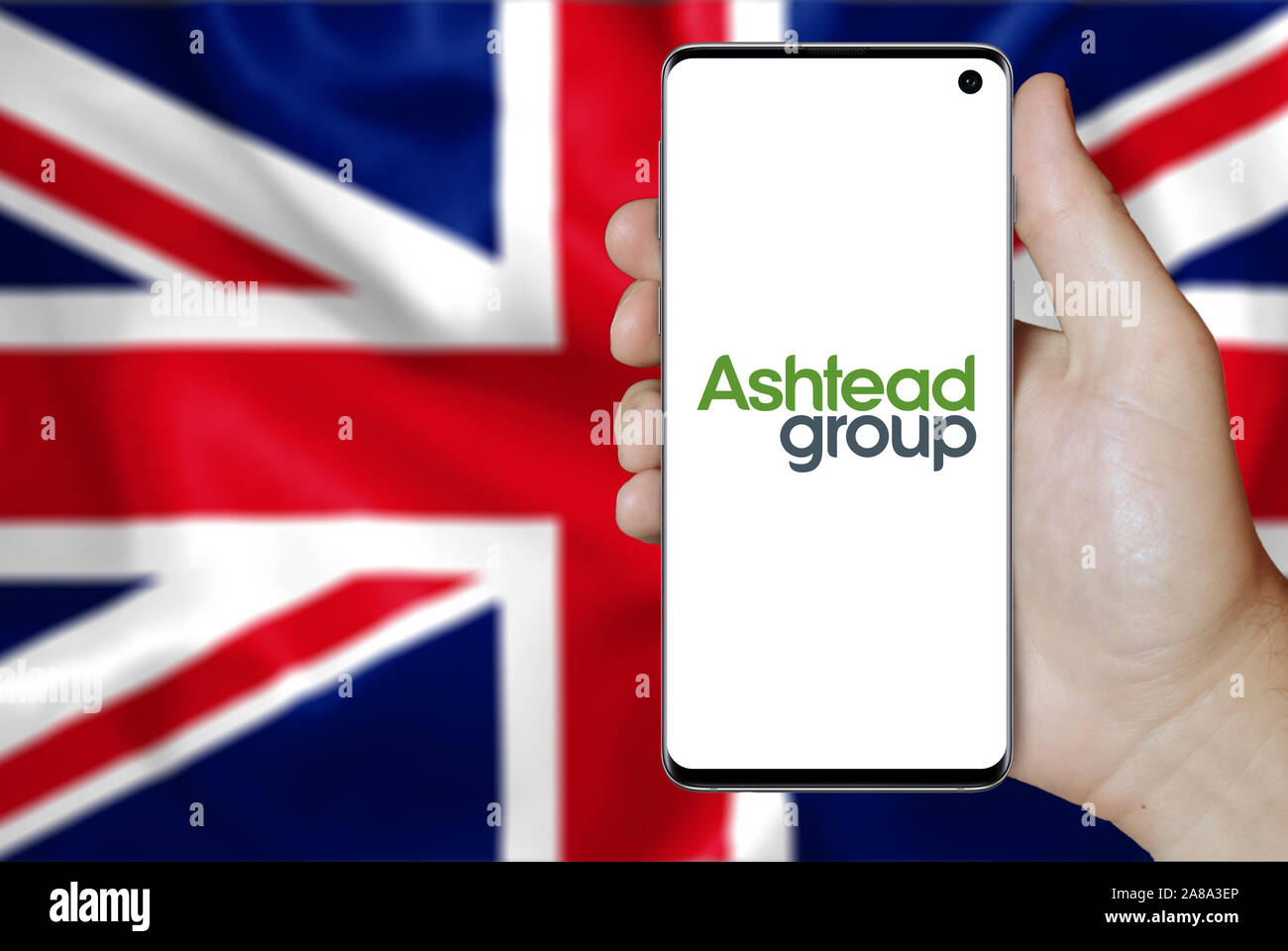 Logo of public company Ashtead Group displayed on a smartphone. Flag of ...
