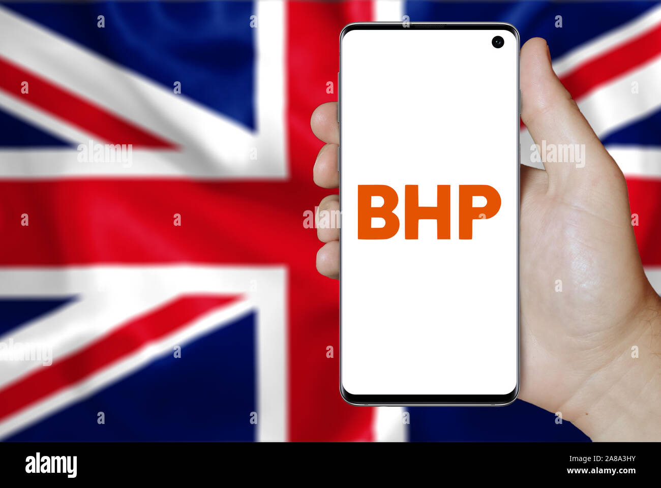 Logo of public company BHP displayed on a smartphone. Flag of UK ...