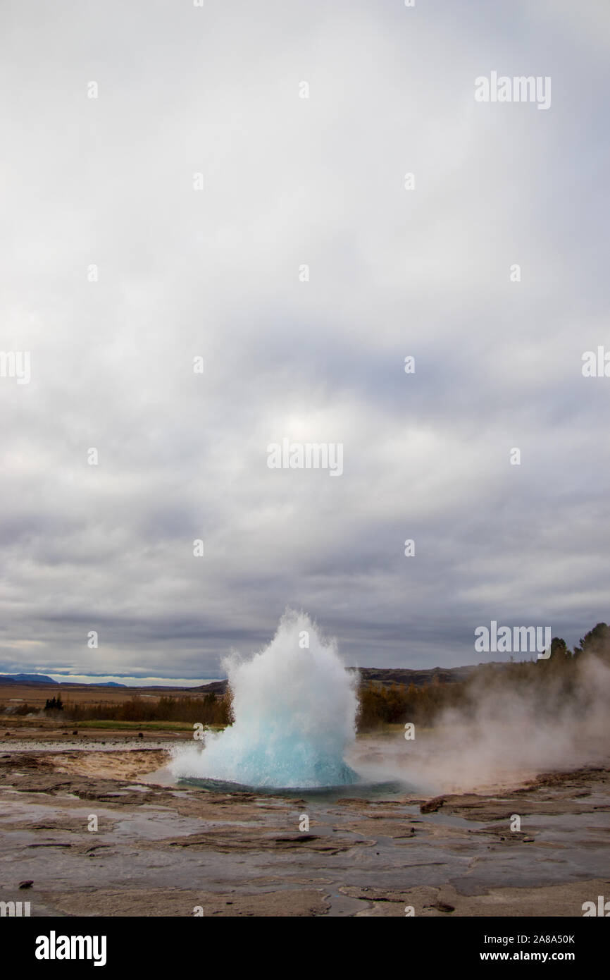 great geyser erupts in Iceland blue Stock Photo - Alamy
