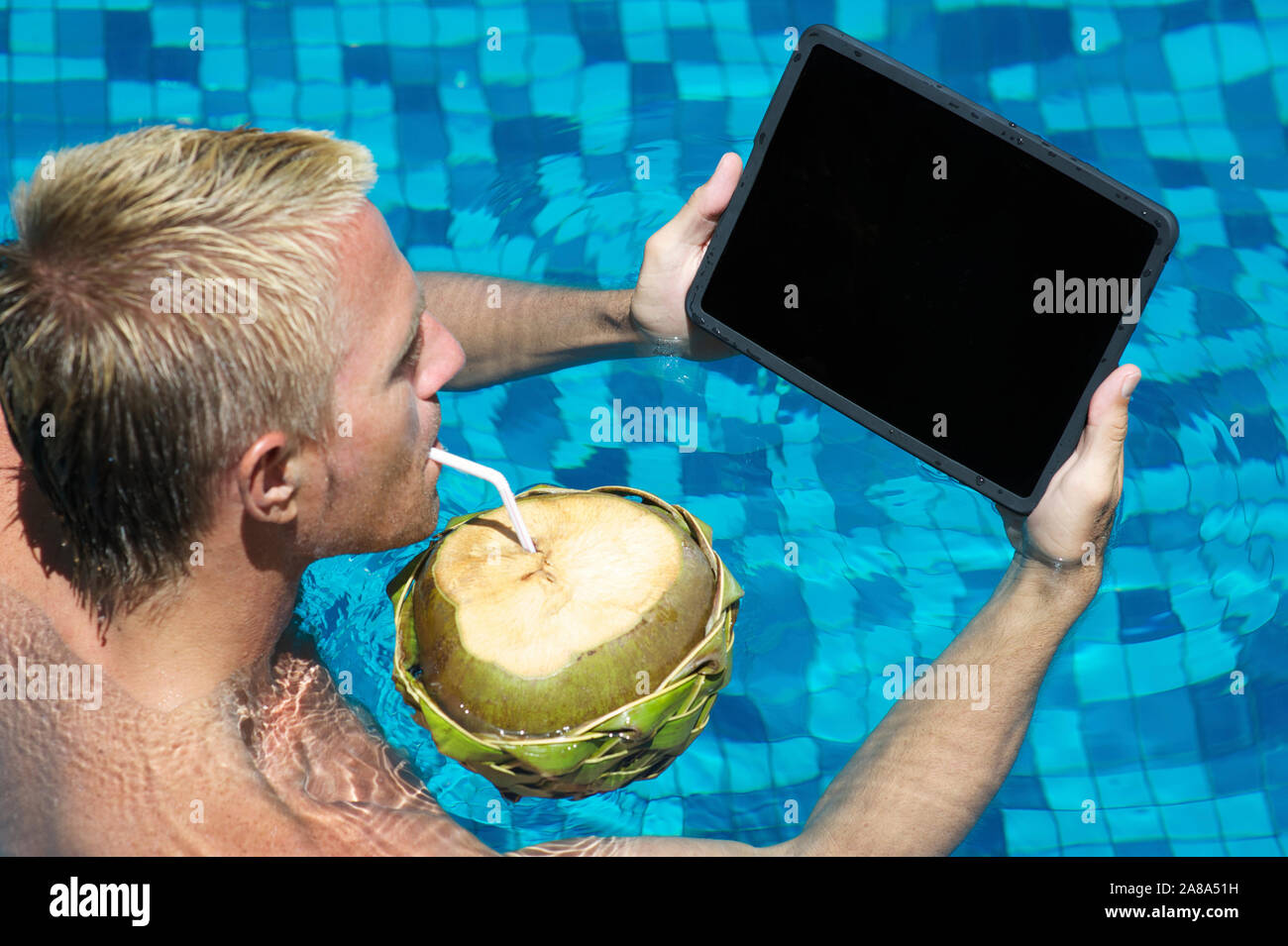 Using computer in swimming pool hi-res stock photography and images - Alamy