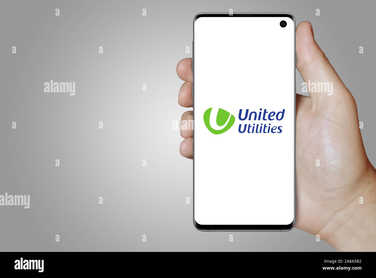 Logo of public company United Utilities displayed on a smartphone. Grey ...