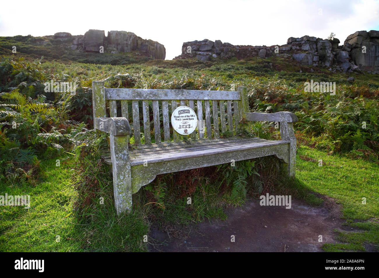 A wooden bench with a sign declaring it to be one of the uks Top Ten ...