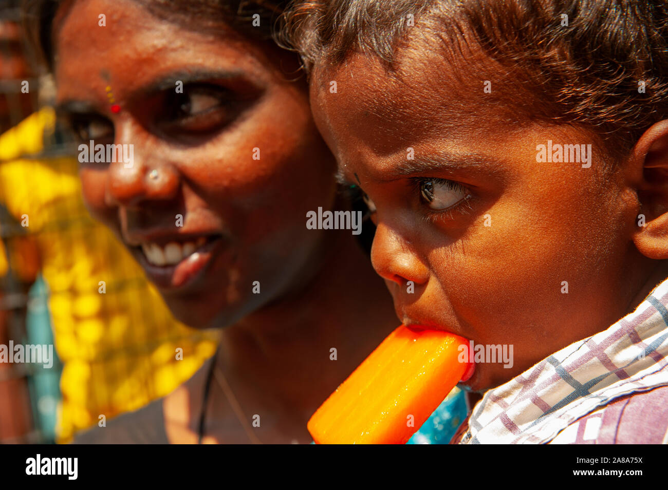 Small indian boy eating a popsicle at Chitradurga Fort, Karnataka ...