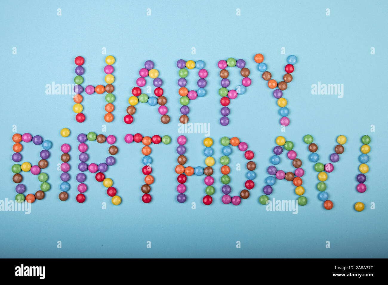 Happy Birthday with light blue background, smarties Stock Photo - Alamy