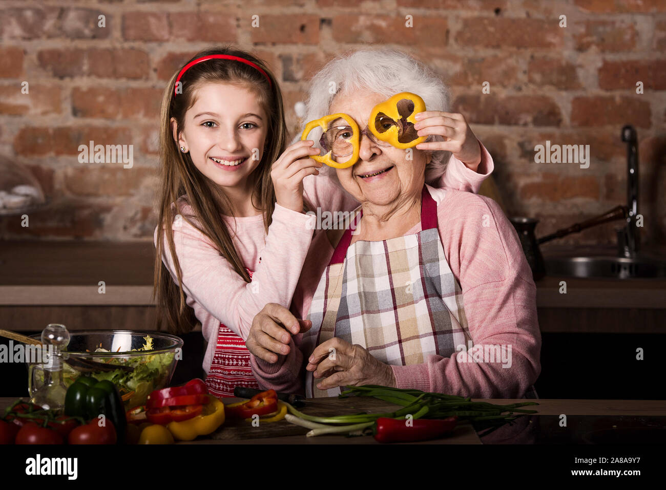 Grandchild with granny having fun Stock Photo - Alamy